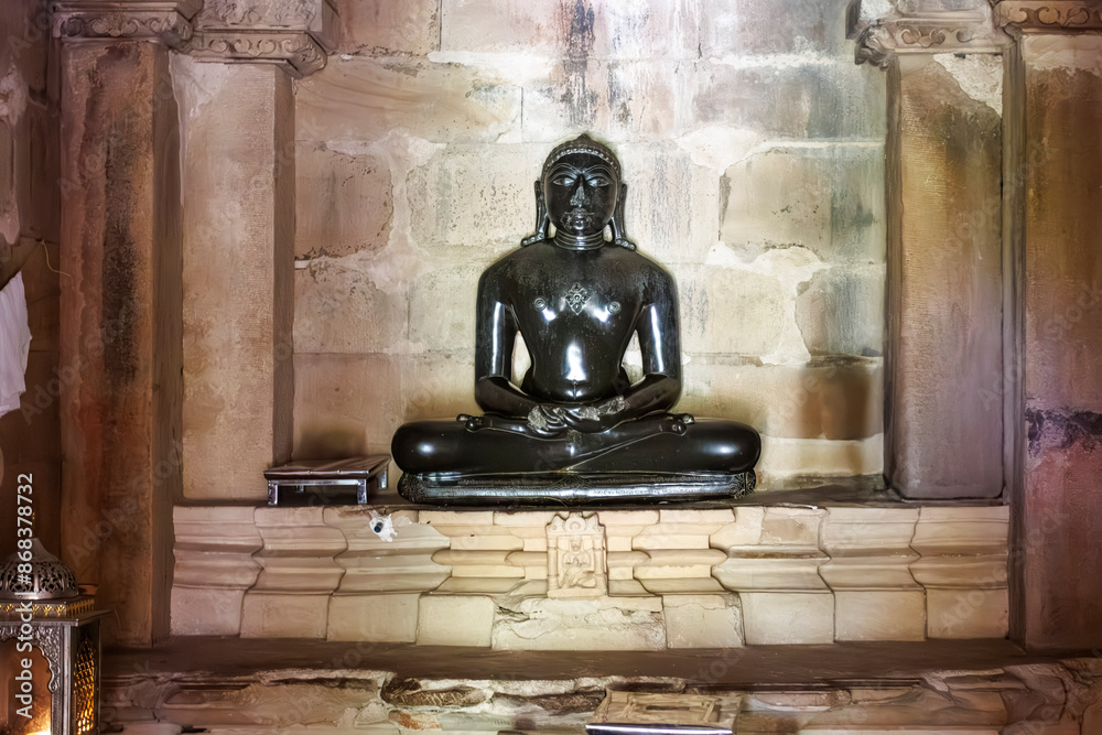Стокове фото Black Chandela-era statue of Adinatha in the sanctum ...