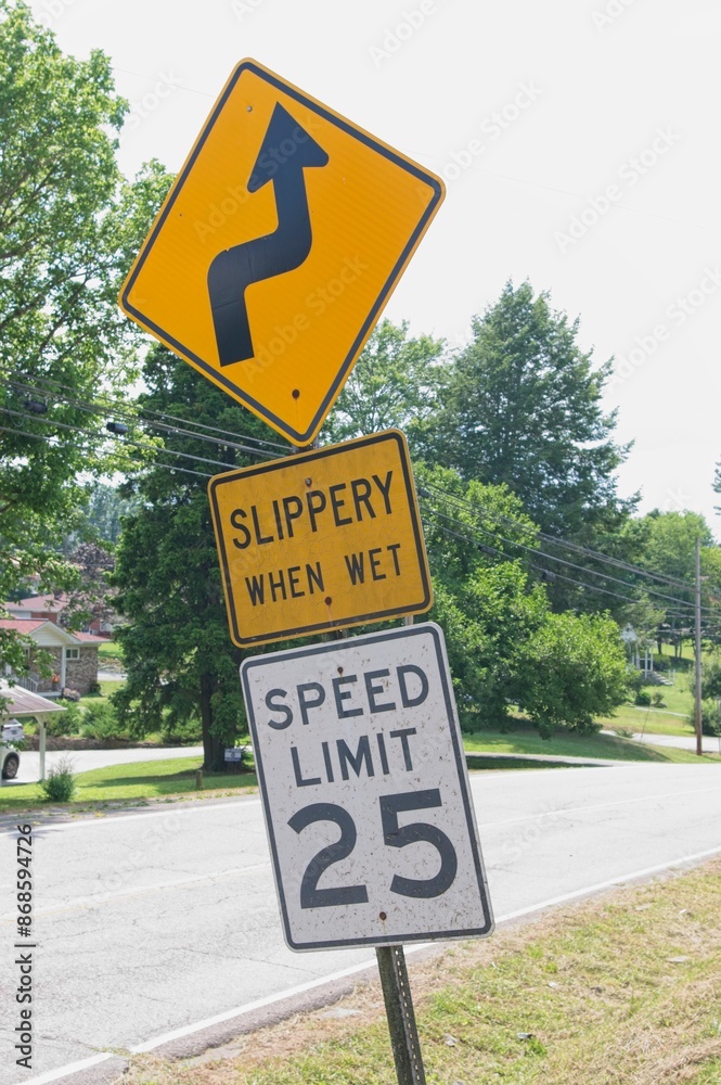 Road signs in a small town warning motorists of speed limit and ...