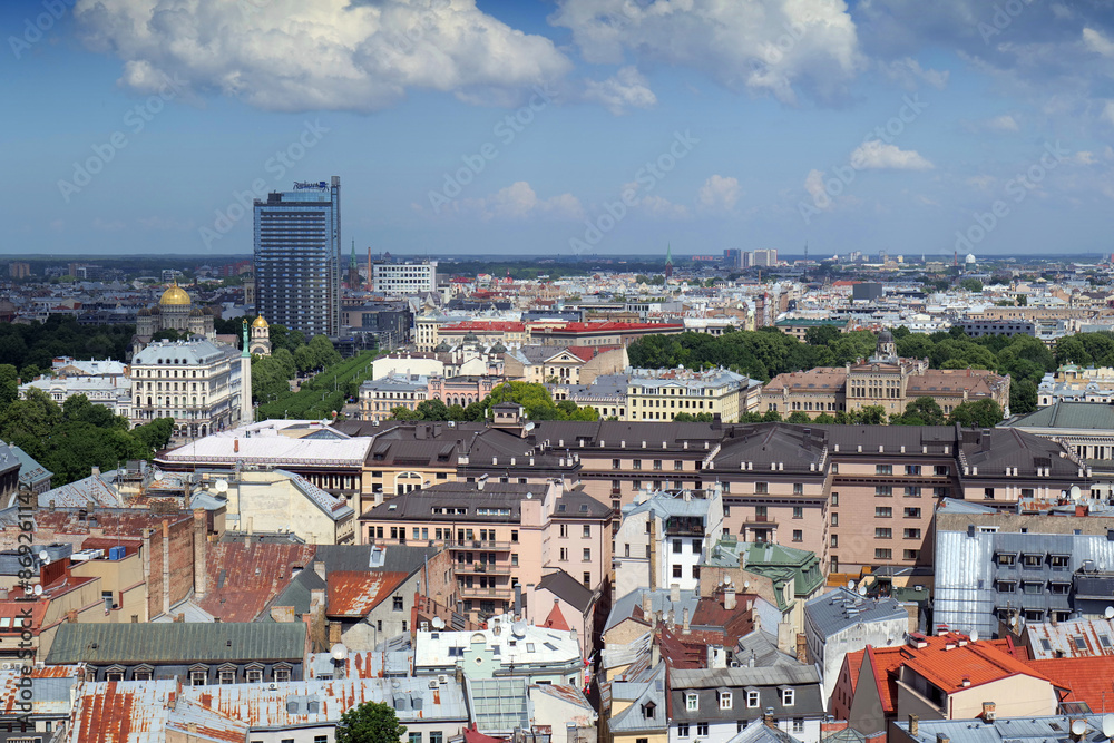 Riga cityscape with modern Radisson Blu hotel behind the golden topped ...