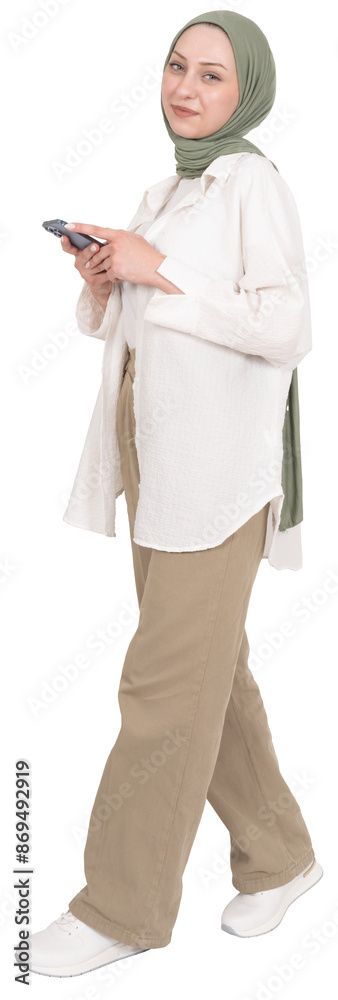 Using smartphone, full body view young caucasian muslim woman wear ...