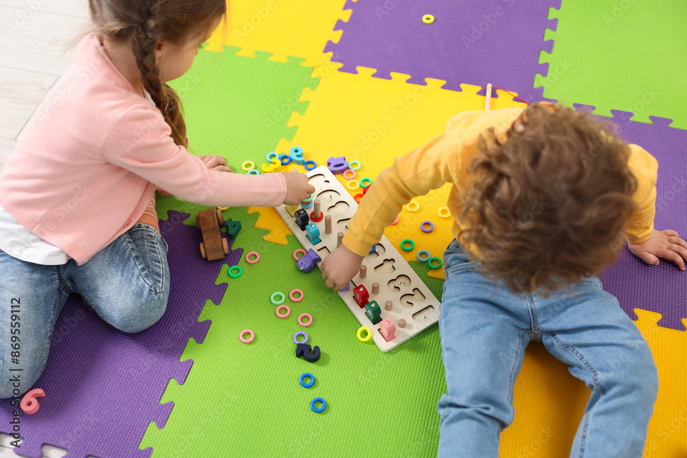 Cute little children playing with game Fishing for Numbers on puzzle ...