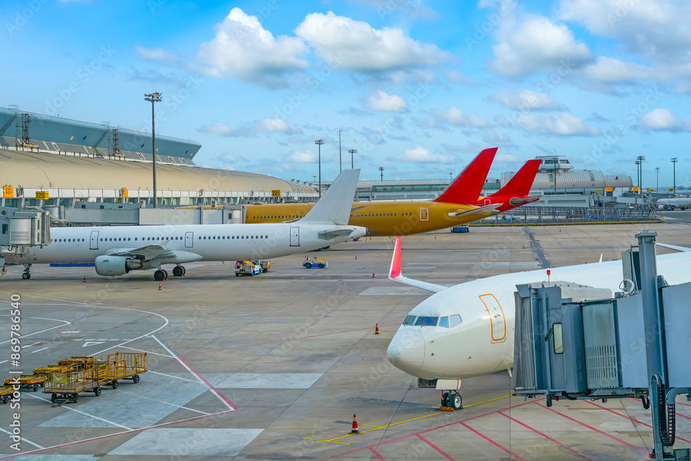 Some aircraft with ladder stairs to the airport parking. View of the ...