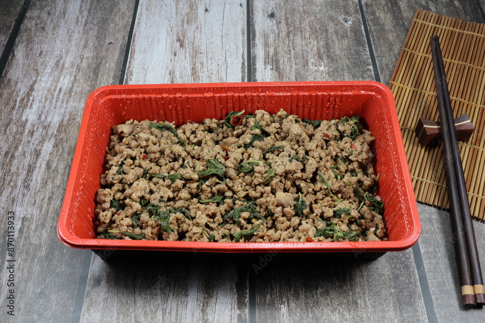 Traditional fried and stirred minced pork with basil and chilly serving ...