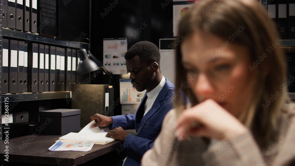 African american detective requests forensic report and suspect ...