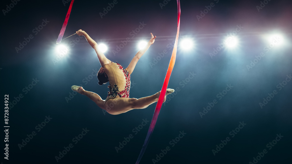 Graceful Female Gymnast in Mid-air, Performing Split Leap With Ribbon ...