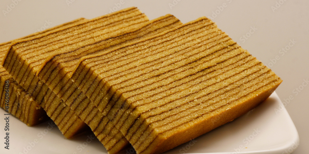 Slices of Indonesian Lapis Cake against dark background. Layered cake ...