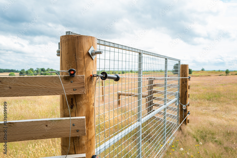 Newly erected farm field gate showing part of an electric fence which ...