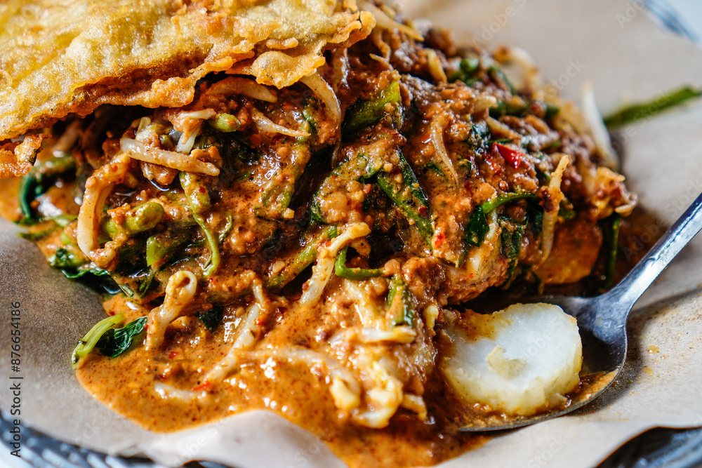 pecel dish consisting of mixed vegetables with peanut sauce and served ...