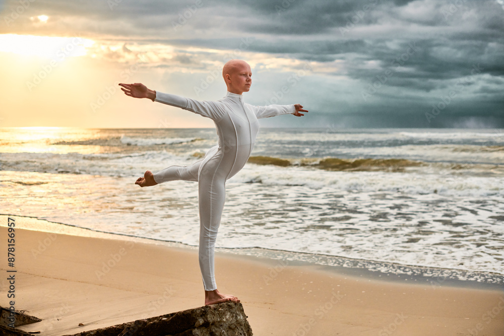 Young hairless ballerina with alopecia in white futuristic suit dancing ...