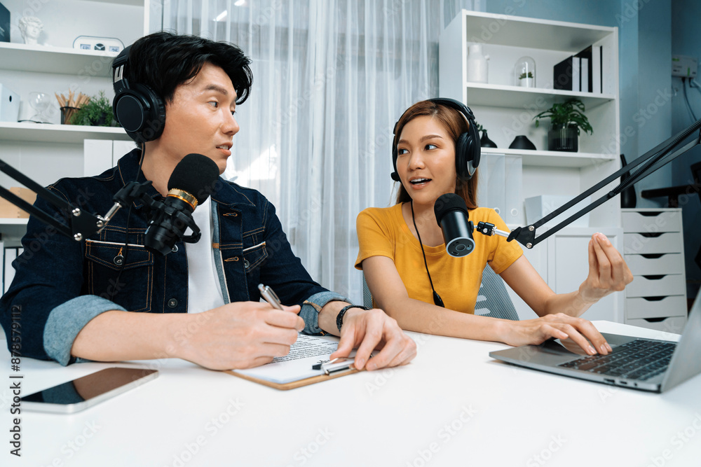 Smiling radio influencer hosts wearing headphones with channel social ...