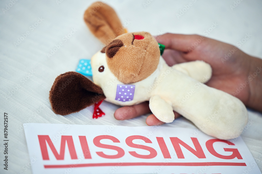 Teddy bear, sign and missing person with hand on bed in house for ...