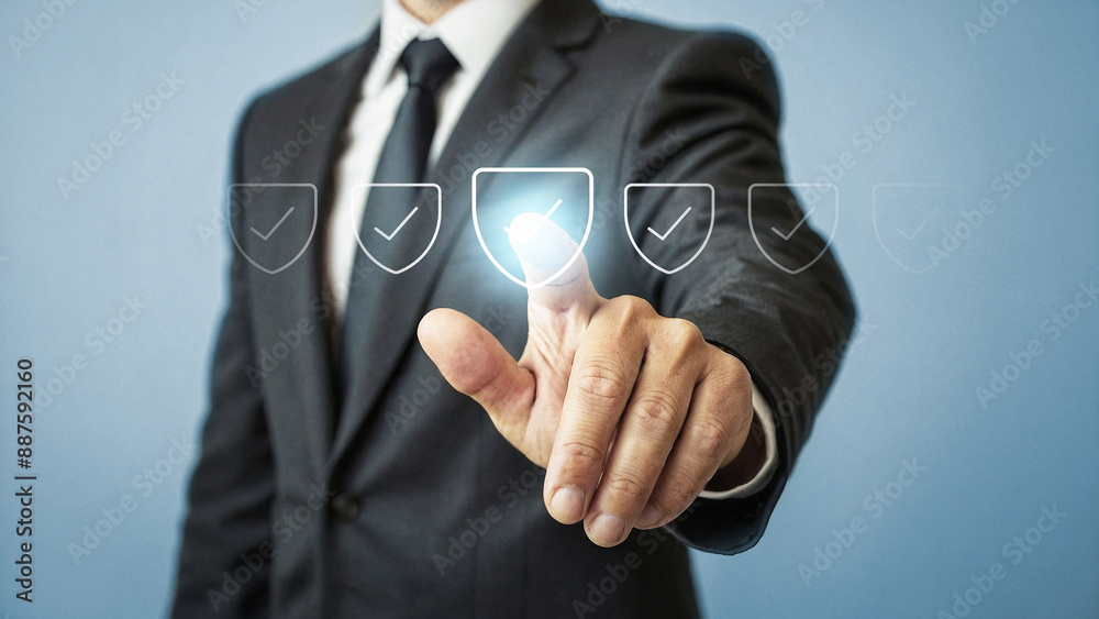 Businessman pressing virtual shield checkmark icon, managing digital security approval and ...