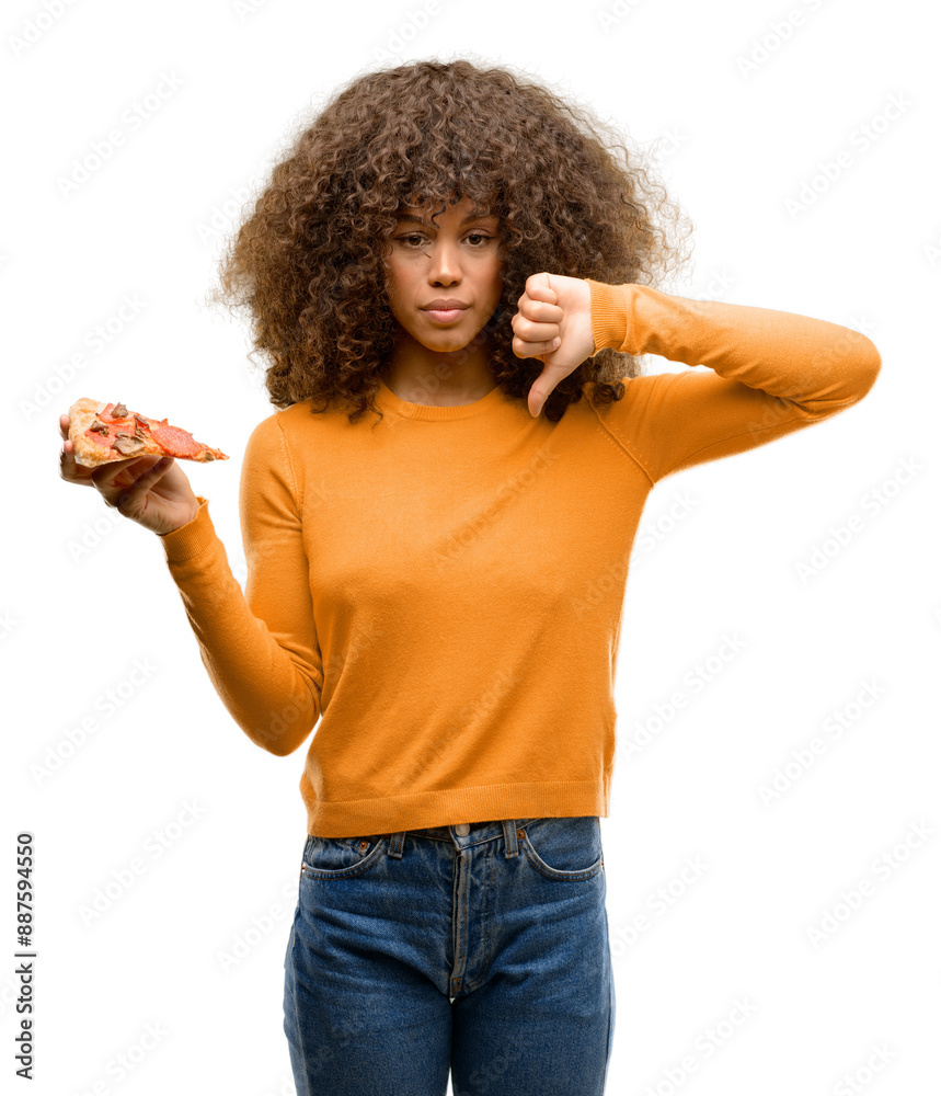 African american woman with a pizza slice with angry face, negative ...