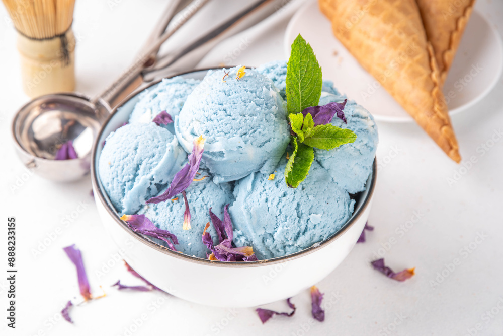 Colorful sweet butterfly pea blue matcha scoops in portioned bowl ...