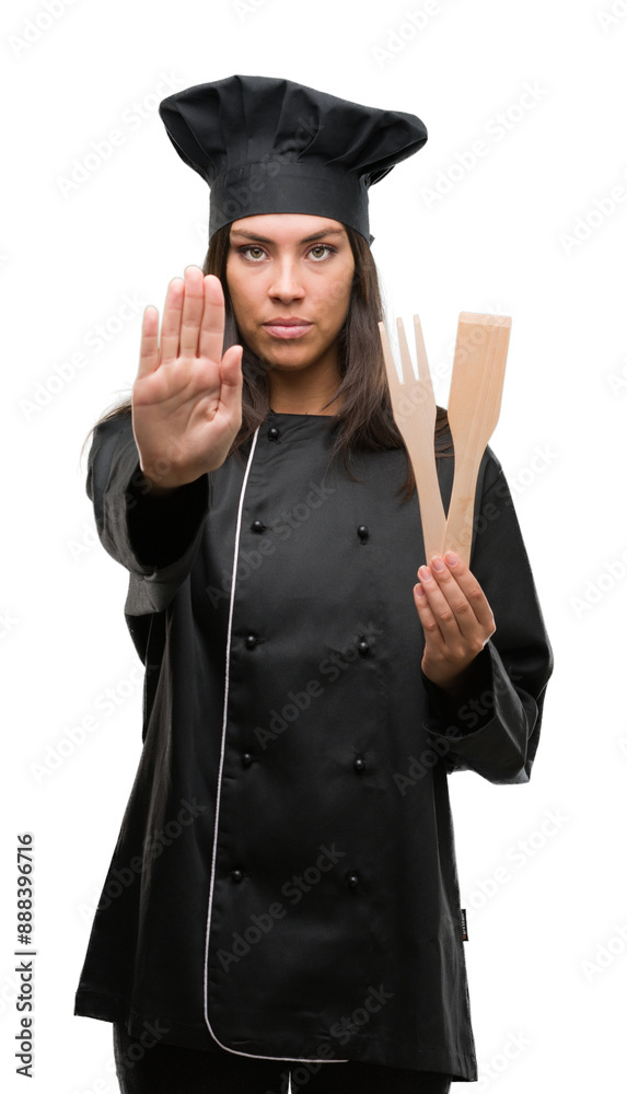 Young hispanic cook woman wearing chef uniform with open hand doing ...