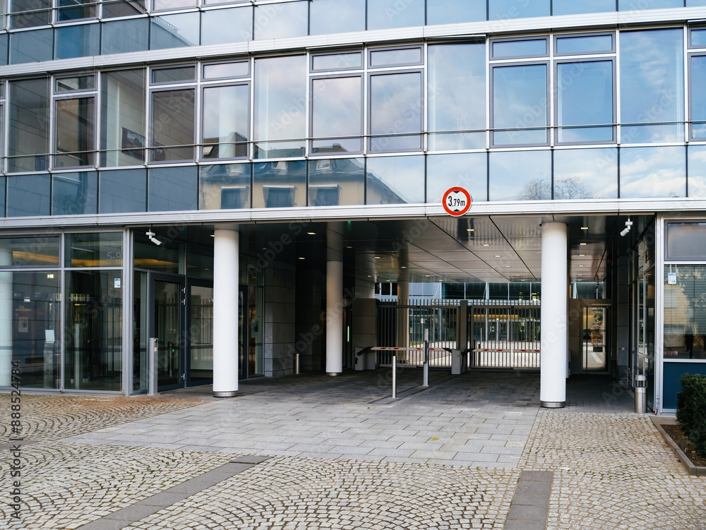 Modern building entrance with glass facade and a height restriction ...