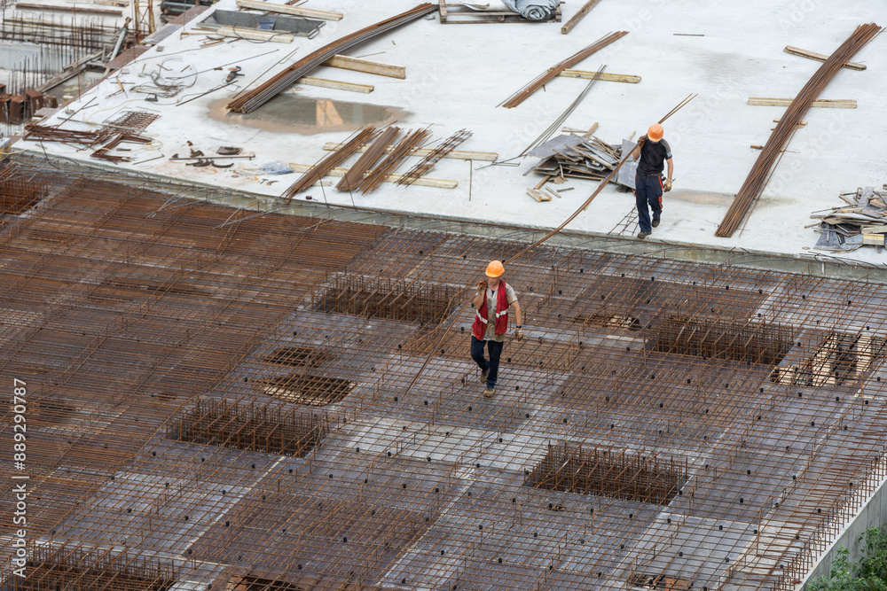 Construction workers install formwork and iron rebars or reinforcing ...
