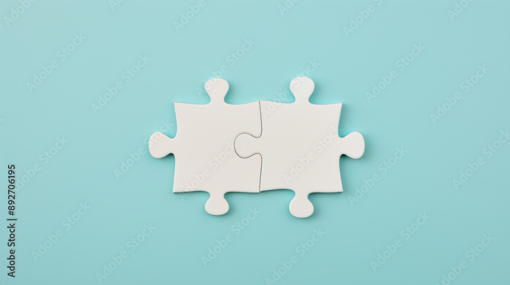two white puzzle pieces matching together againt light blue background ...