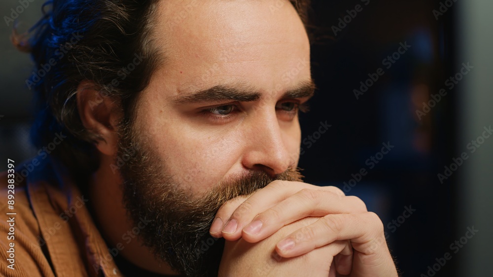 Programmer in home office concentrating on finding bugs while doing coding on computer, extreme ...