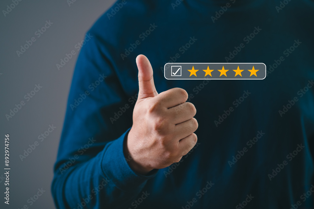 Close-up of a hand showing a thumbs-up gesture with a five-star rating ...