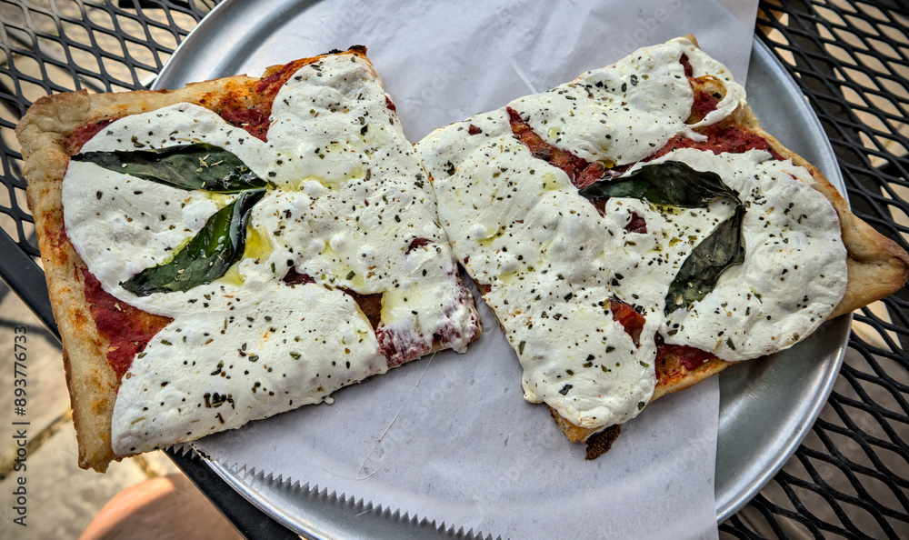 two square slices of sicilian style pizza (fresh white mozzarella basil ...