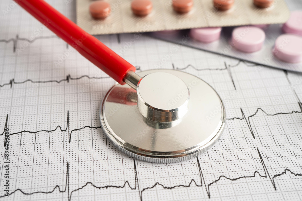 Stethoscope on electrocardiogram (ECG) with red heart and drug, heart ...