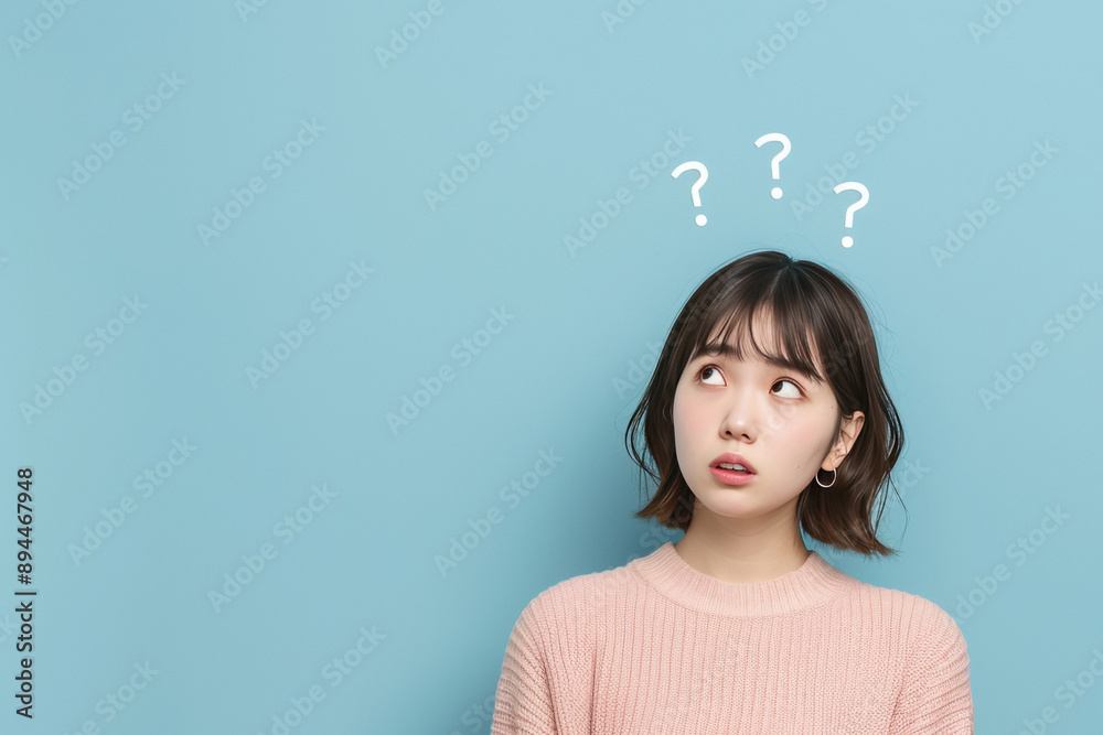 young beautiful girl thinking with question mark Stock Photo | Adobe Stock