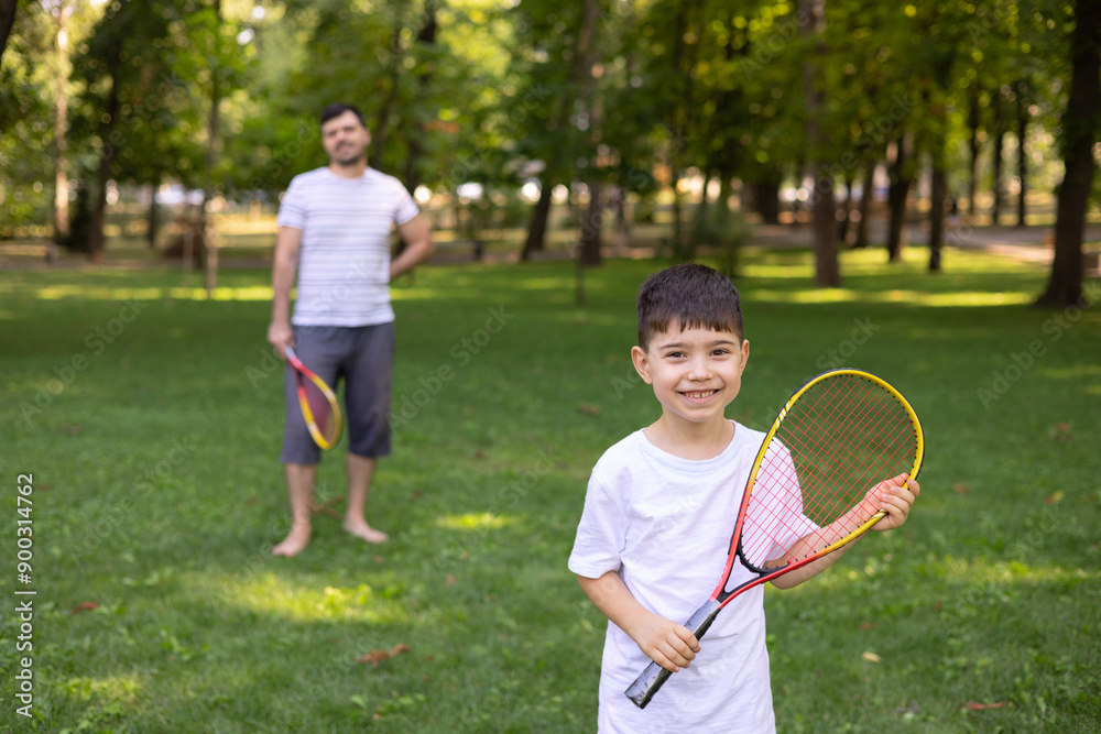 dad and son,kid and man playing outside in park badminton.child boy and ...