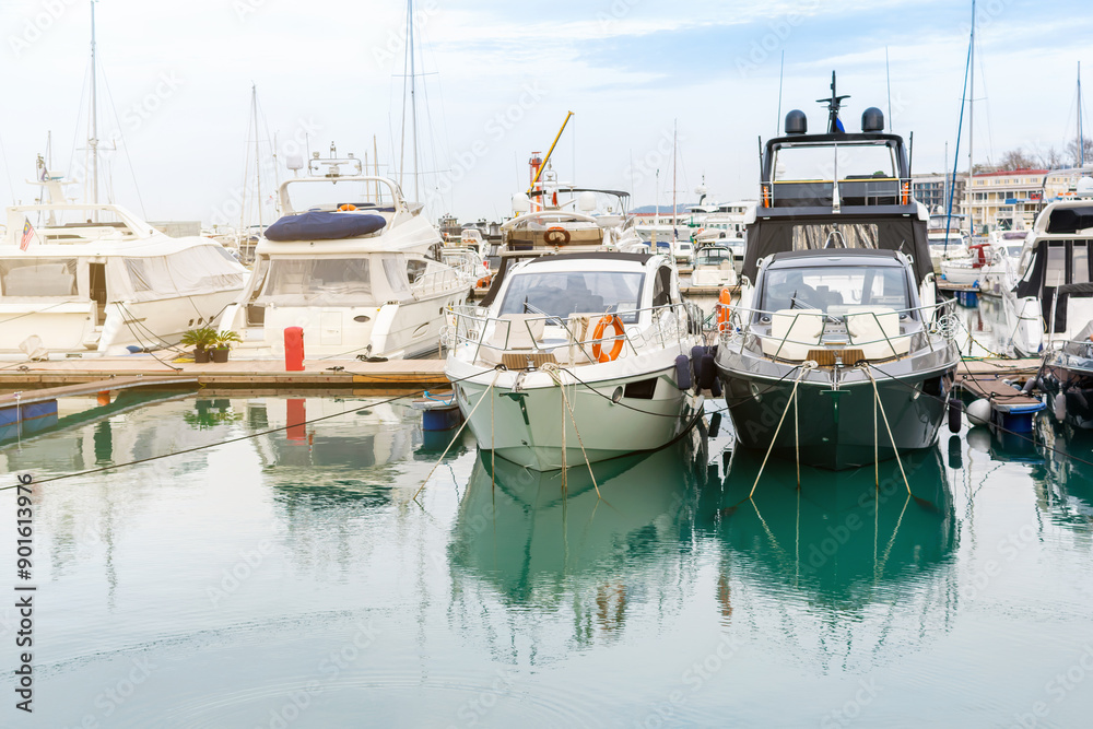 Modern white yachts in the seaport marina. Sea berth pier for mooring ...