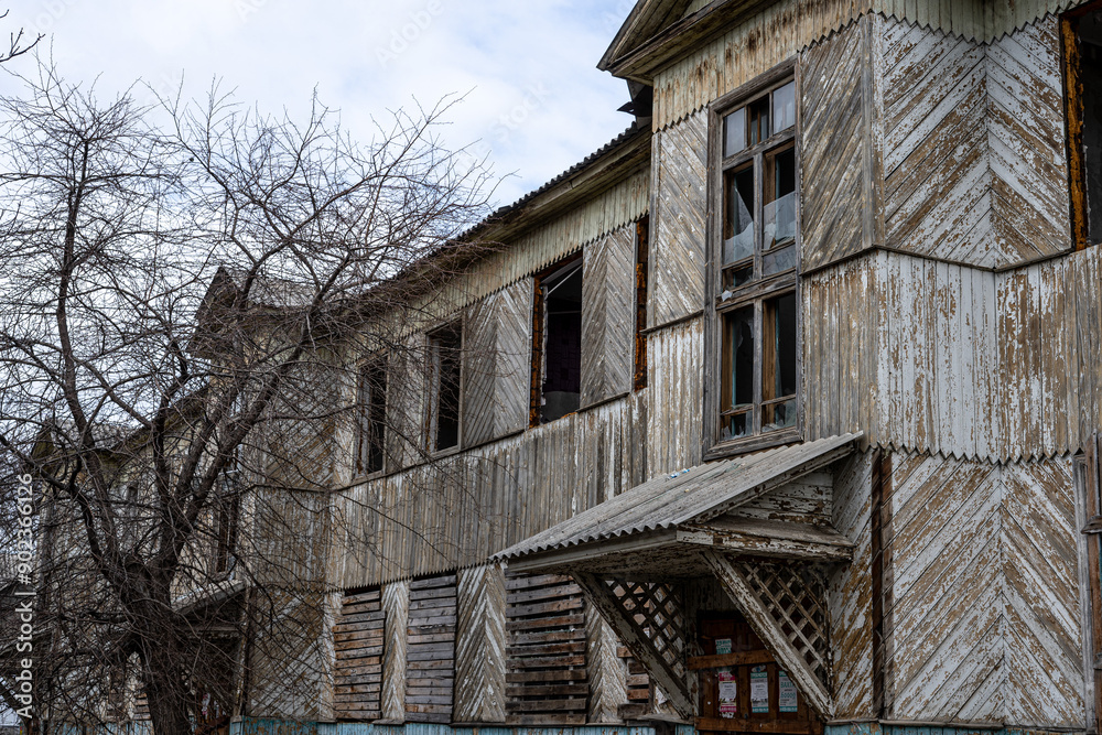 Boarded up windows. An old abandoned wooden house with boarded up ...