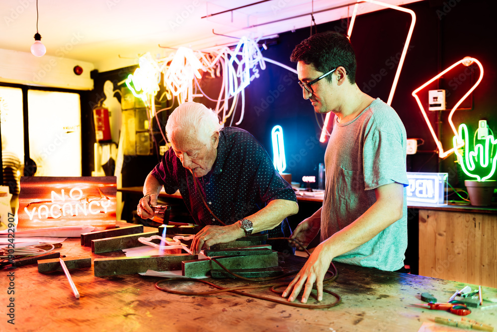 Focused men working at wooden table in signboard workshop Stock Photo ...