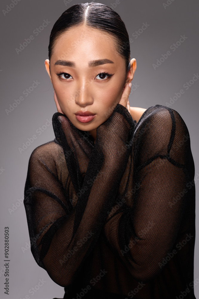 Asian woman sheer top posing camera hands face fashionable and stylish ...
