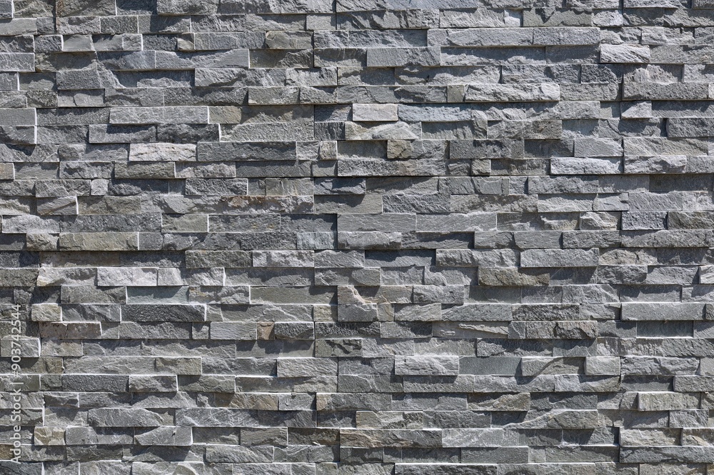 Stone coating wall made of striped stacked bricks of natural gray rocks ...
