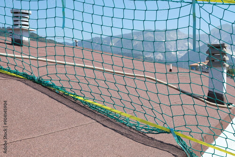 Safety net. Roof safety net.Satellite dish on a roof with a fall ...