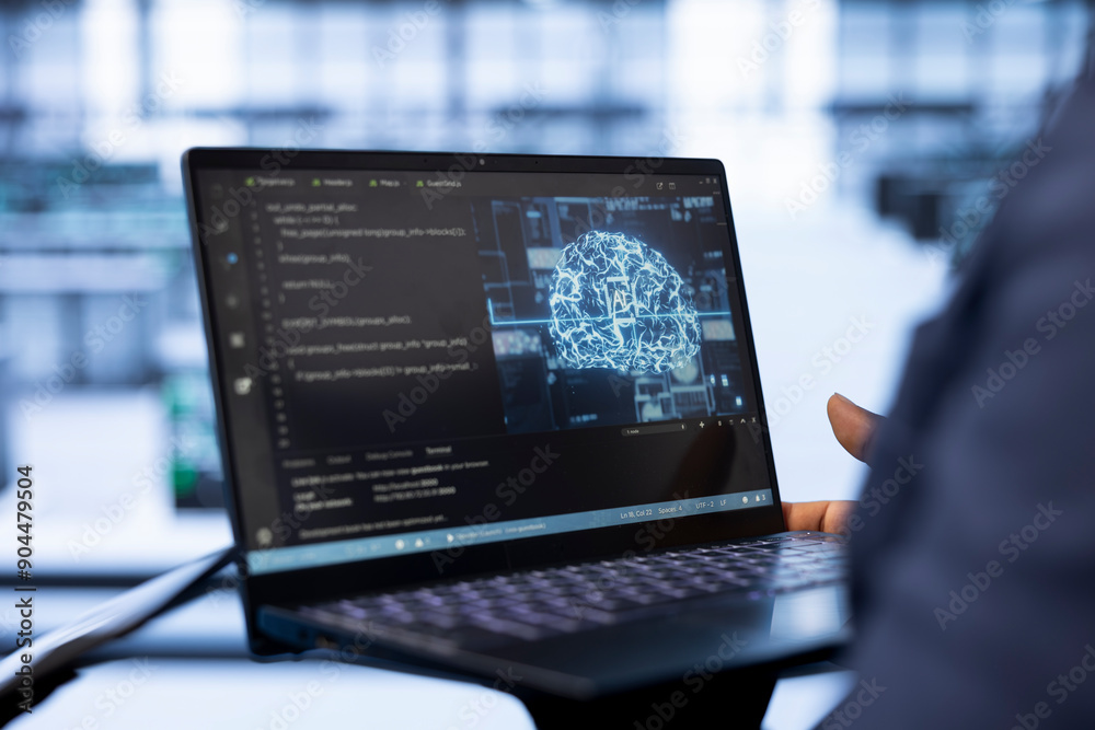 System administrator using laptop in data center, updating AI systems ...
