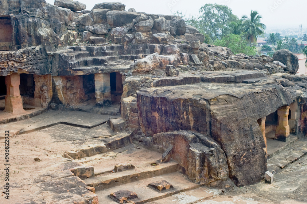 Monks' cells cut into the hillside rock among the Udayagiri and ...