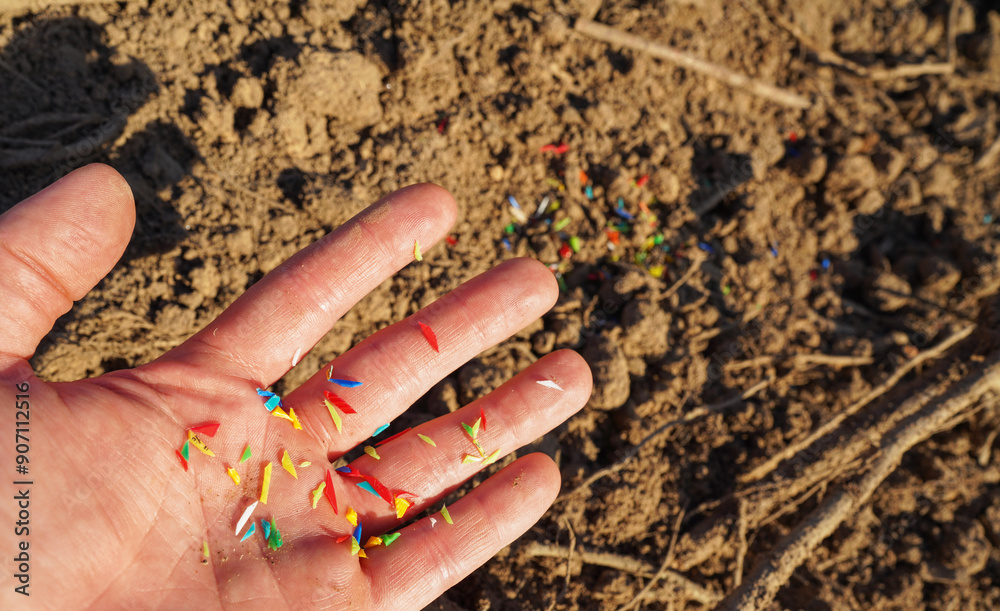 Microplastic pollution. Microplastics in ground. Soil contaminated with ...