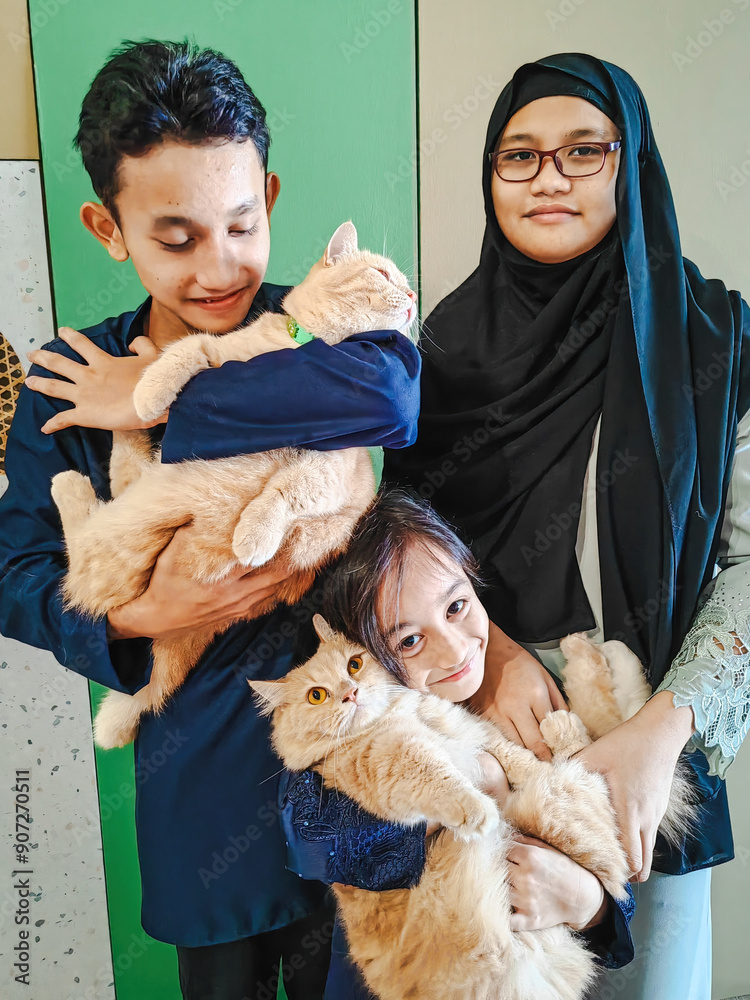 Family and Siblings concept celebrating eid fitr with cats. Asian Malay ...