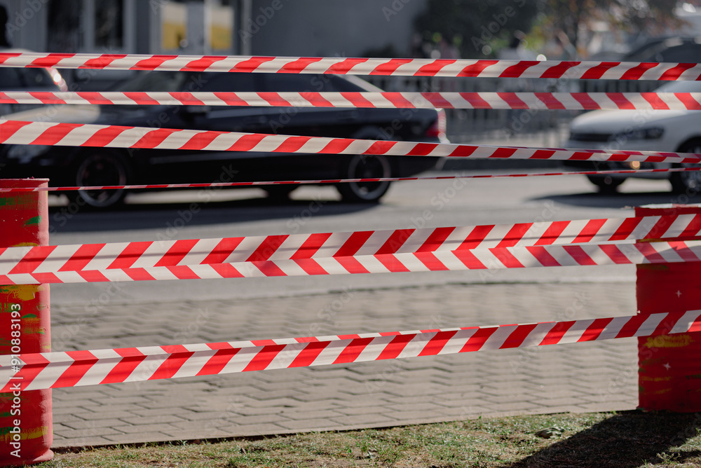 Red and white protection tape defining the border of dangerous zone ...