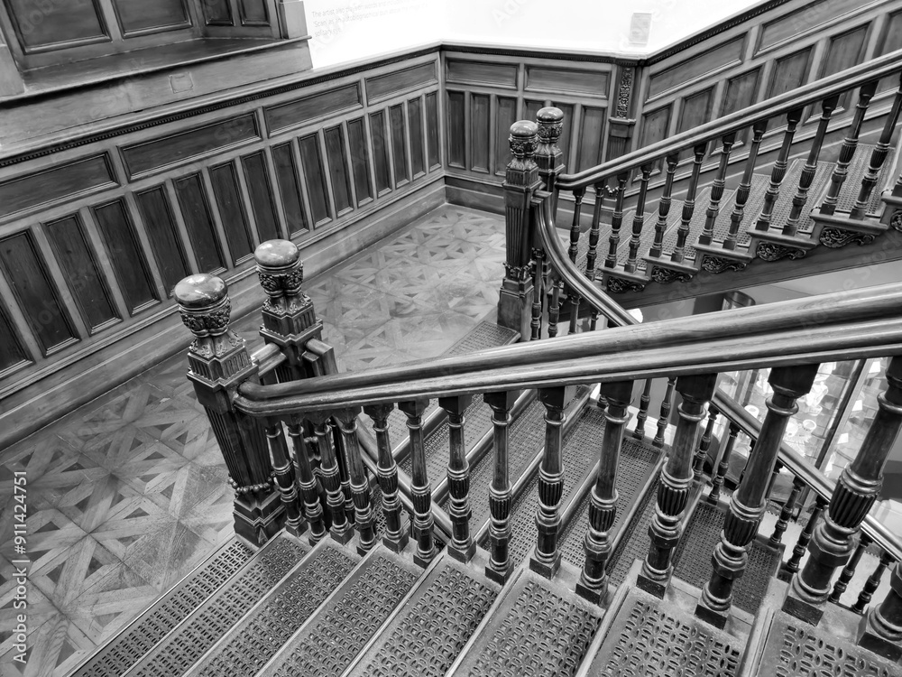 Vintage wooden stairs and railings in the old mansion interior close ...