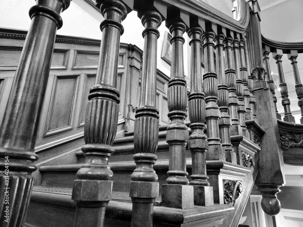 Vintage wooden stairs and railings in the old mansion interior close ...