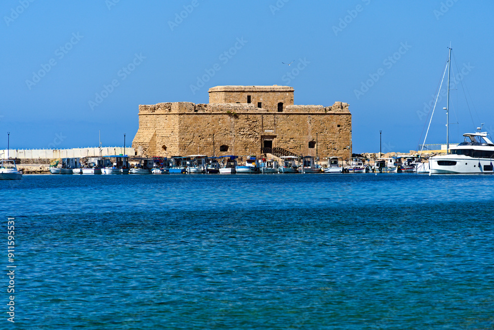 fishing boats and ruins of a medieval stone castle in the port of ...