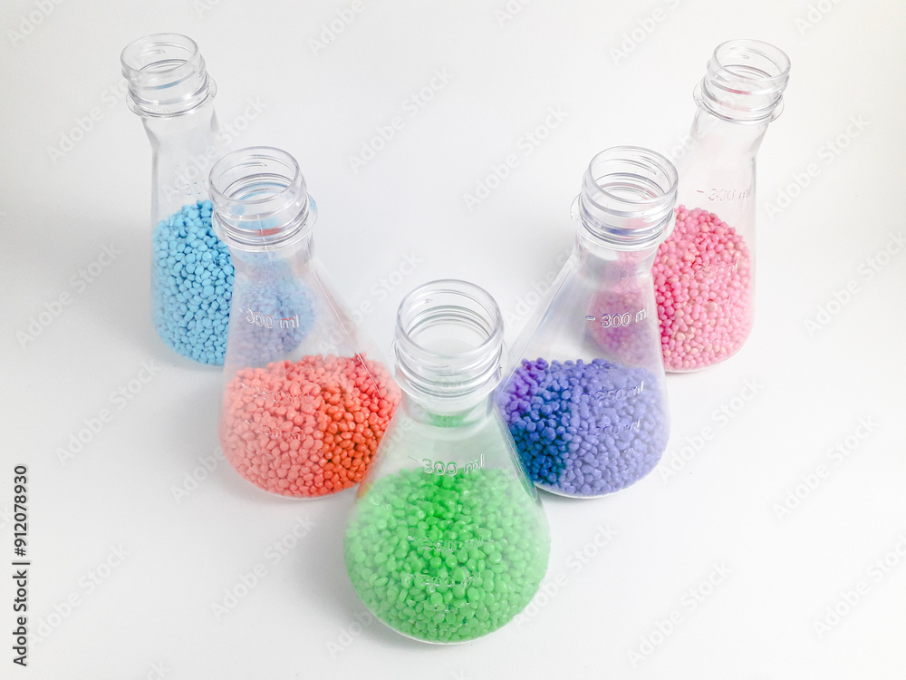 Various colors of masterbatch granules in Erlenmeyer flask isolated on ...