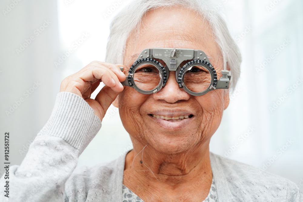 Asian senior woman wearing ophthalmic vision eye test and using optical ...