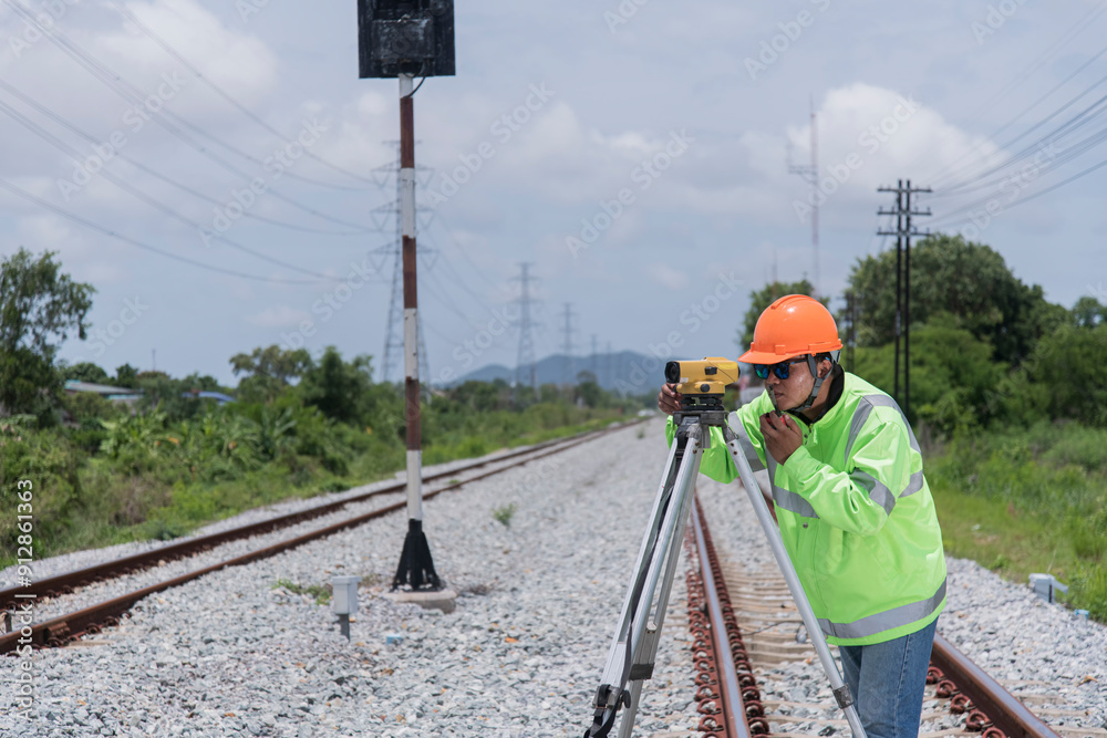 Surveyor builder site engineer with theodolite total station at Railway ...