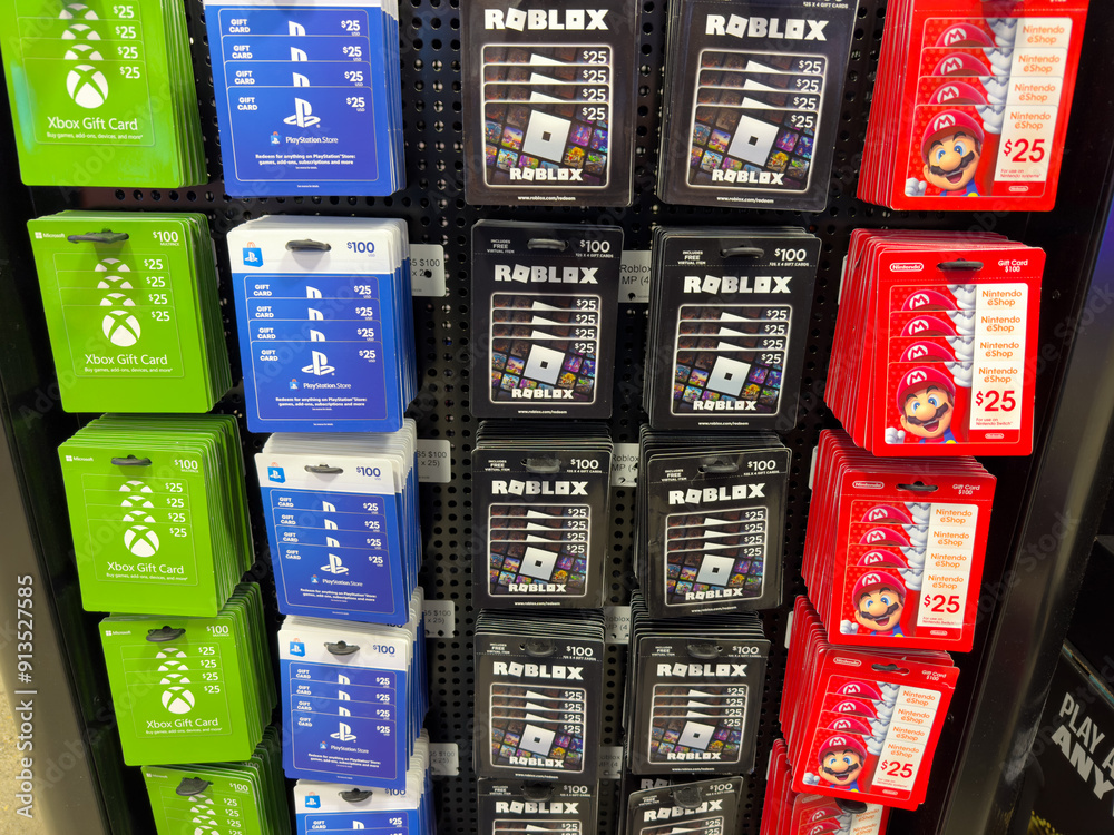 Roblox, PlayStation and Nintendo game store gift cards on a rack inside ...