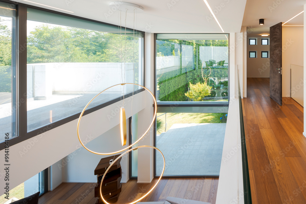 Corridor with parquet floor and glass balustrade. Downstairs you can ...