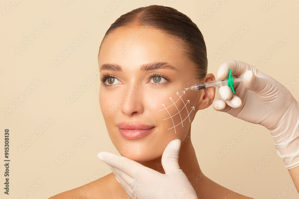 Beauty injections. Lifting lines on young woman's face showing skin ...