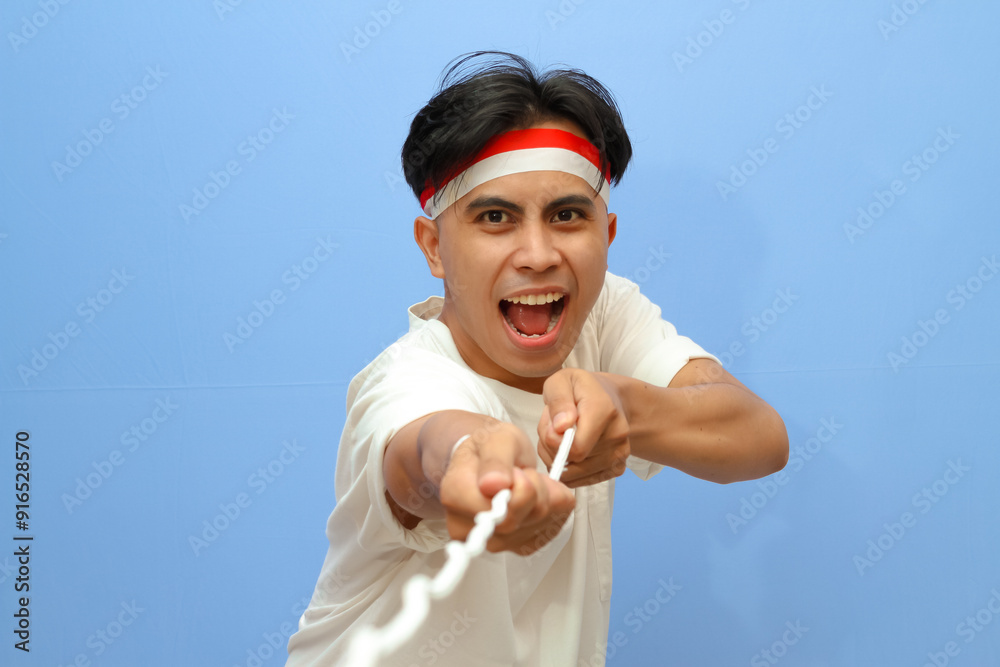 Indonesian man in white shirt and Indonesian flag posing pulling on a ...
