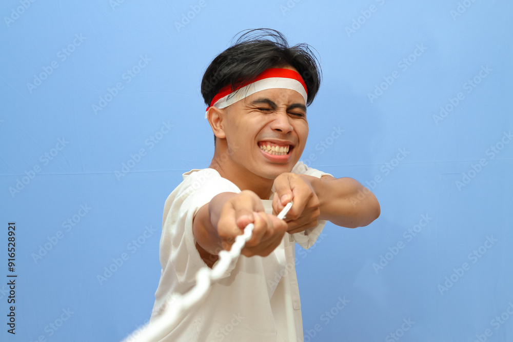 Indonesian man in white shirt and Indonesian flag posing pulling on a ...